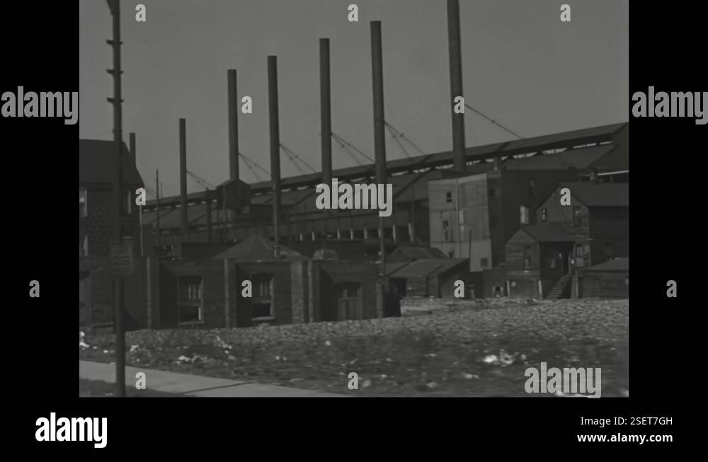 1940s: Run-down urban neighborhood with decaying houses, overshadowed ...