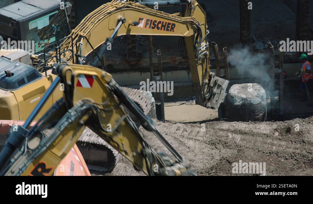 Excavator breaking, digging and loading stone into truck CloseUp Stock ...