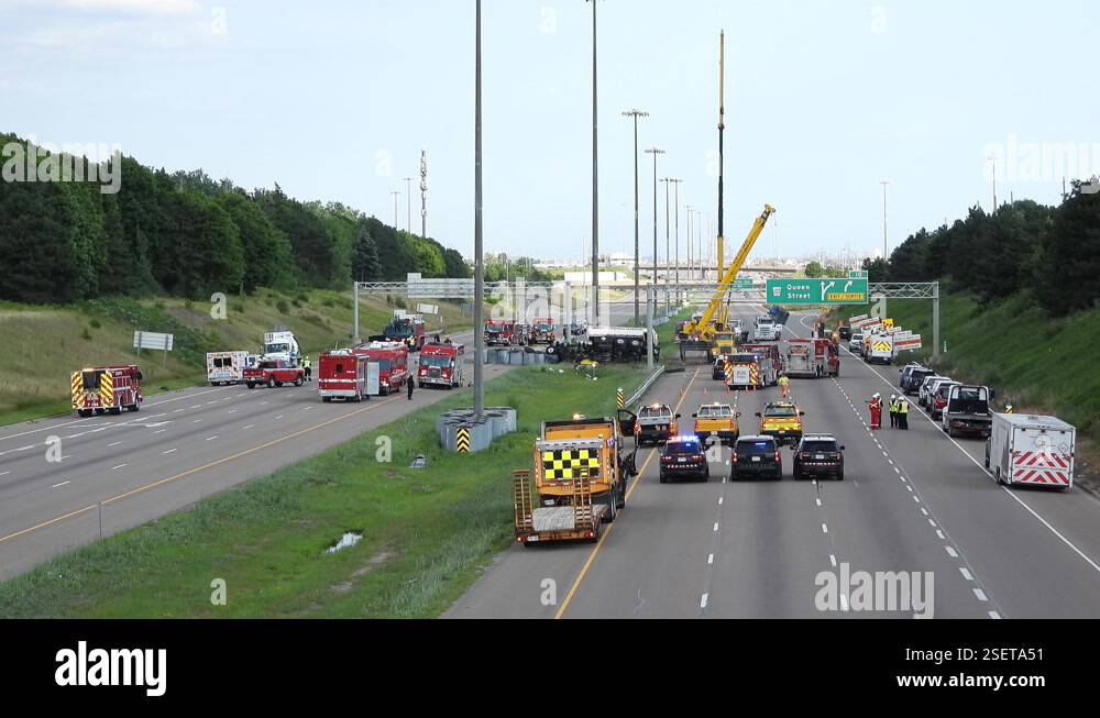 Fire Trucks, Police Cars, And A Mobile Crane Clearing The Debris At An ...