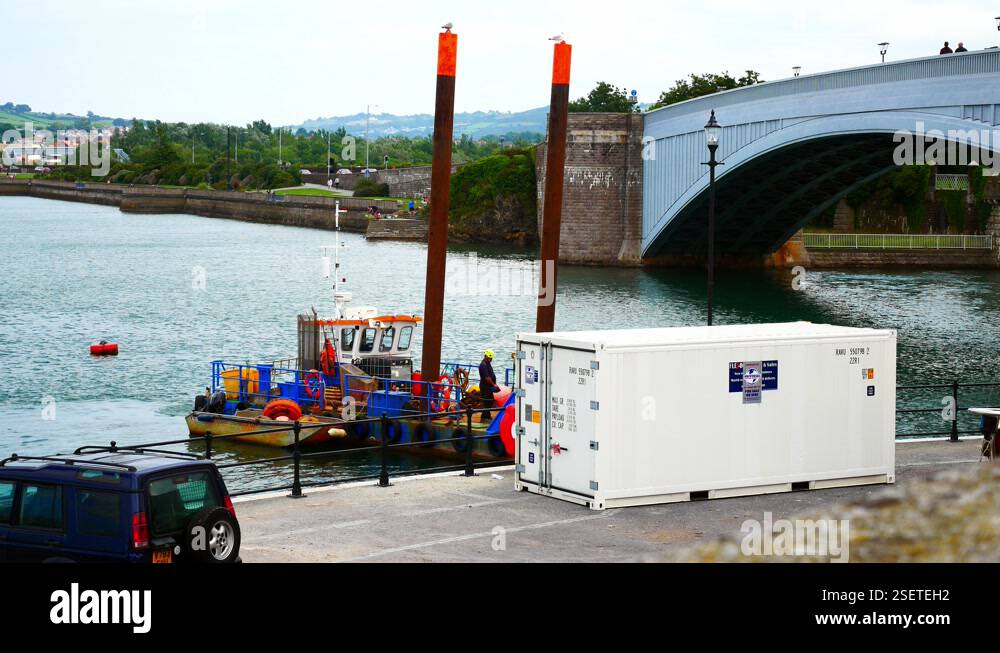 Colourful small crane boat mooring on Conwy harbour walls North Wales ...
