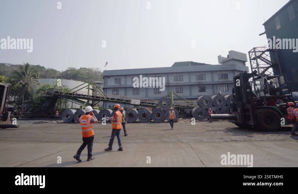 People working at steelworks, in sunny Goa port, India - slow motion ...