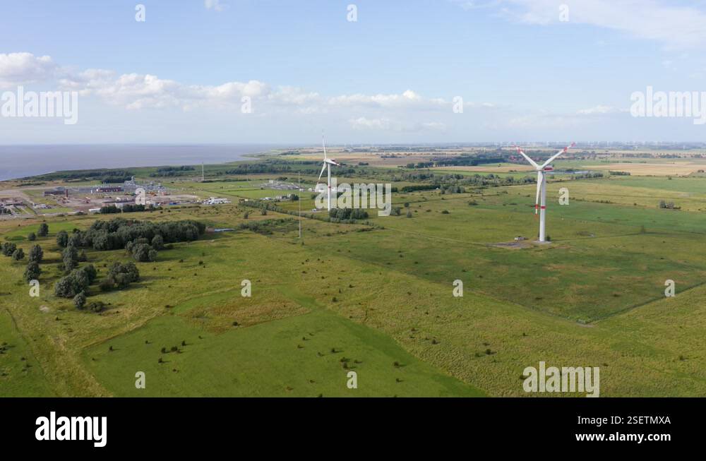 Cinematic aerial view of large wind turbines producing clean ...