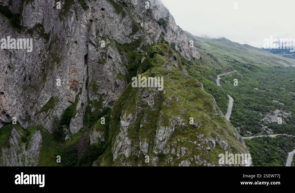 rocky mountain slope overgrown with greenery close-up mountain valley ...