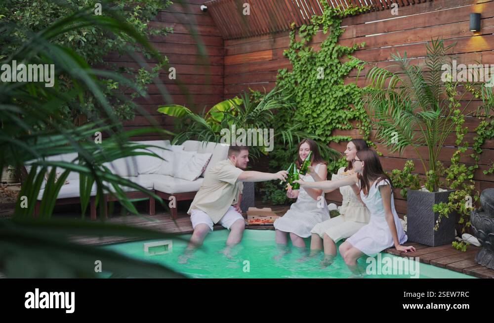 Celebration in the pool. Friendship of a group of people. Toast, beer ...