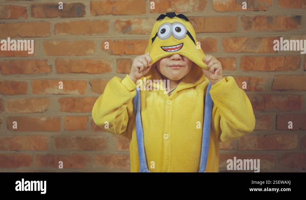 Cheerful boy in minion pajama smiling. Cartoon character costume. Crazy ...