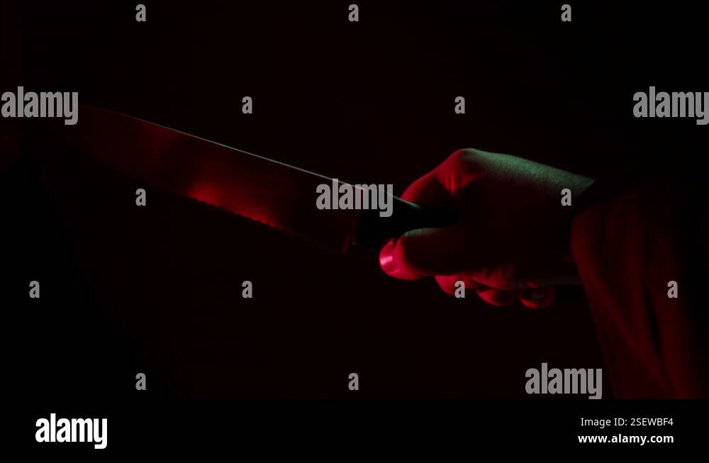Reflection of evil killer in knife close-up. Psycho murderer using ...