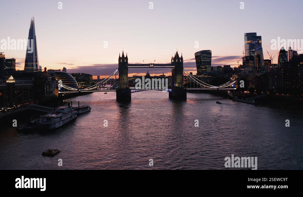 Crane up footage of famous Tower Bridge over River Thames. Illuminated ...