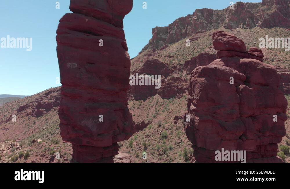 Retreating aerial reveals tall narrow sandstone pillars in Utah desert ...