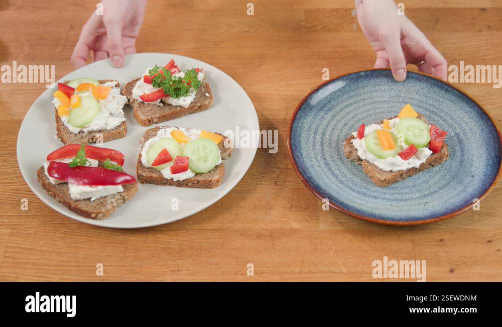 Two ceramic plates: one with four delicious sandwiches, second with one ...