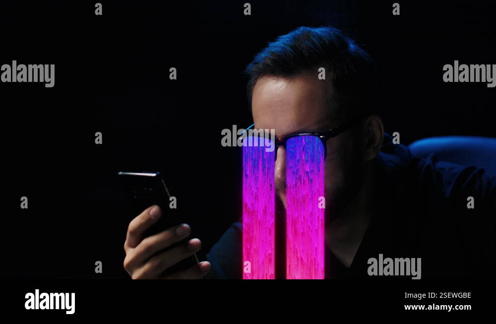 Young Man Looks into Phone and Scrolling Web Content and Like Photos ...