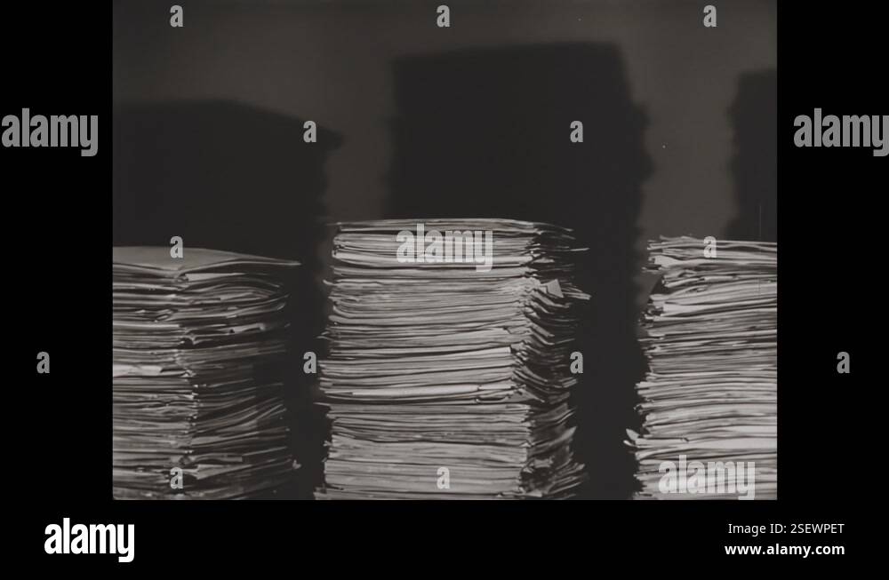1930s: Movie reel. Animation of paper piling up. Woman writes a letter ...