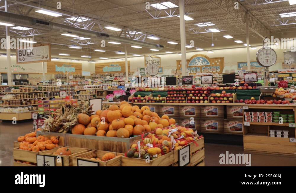 Sprouts retail upscale grocery store interior pan of people wearing ...