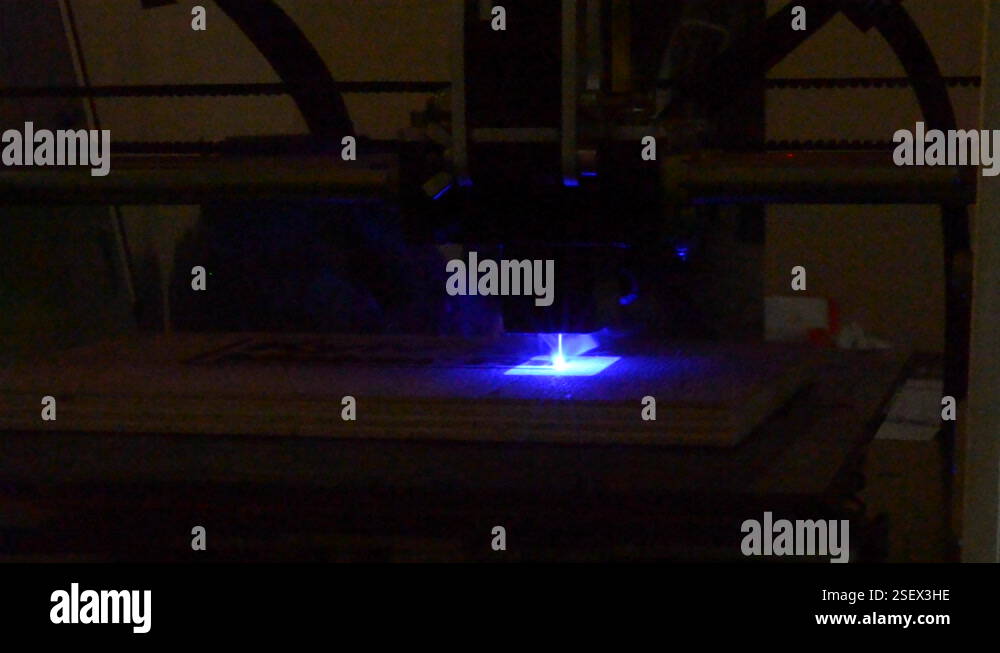 Laser engraving on wood. 3D printer laser beam burns the pattern Stock ...