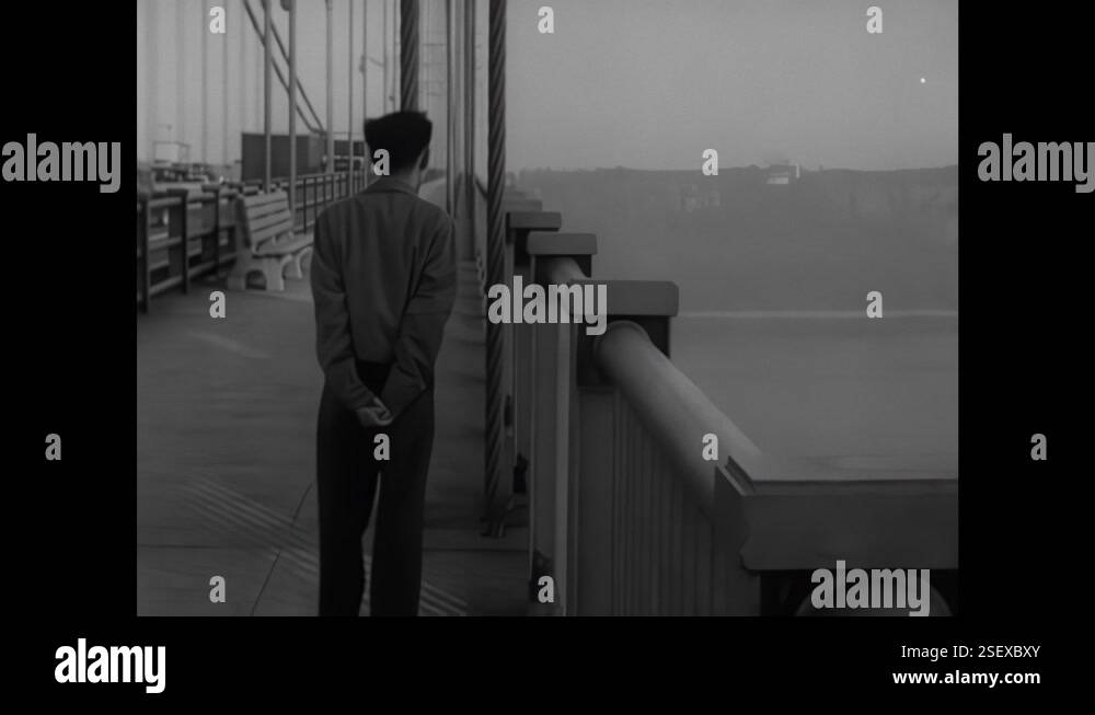 1950s: Man on the George Washington Bridge leaves the railing and look ...