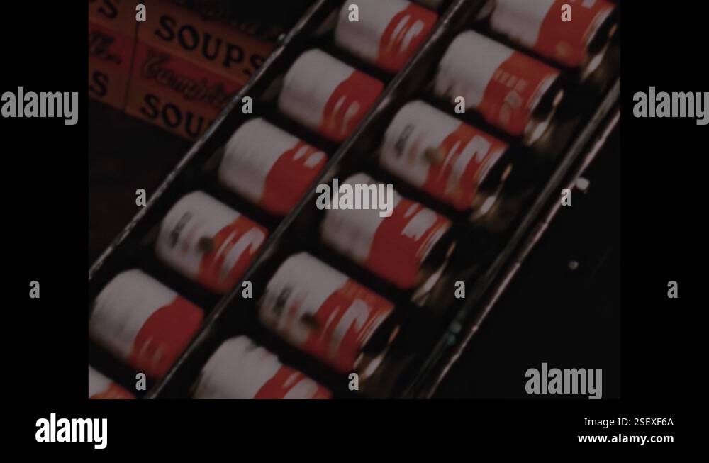 1950s: Campbell's soup cans travelling along assembly line. Soup cans ...