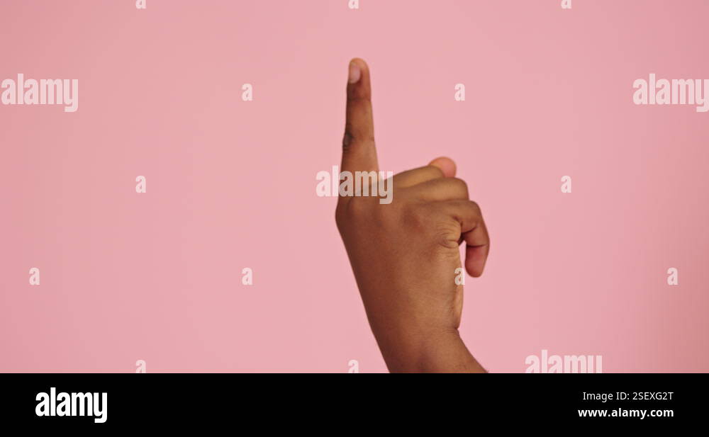 African american man hand reversed finger up gesture isolated on pink ...