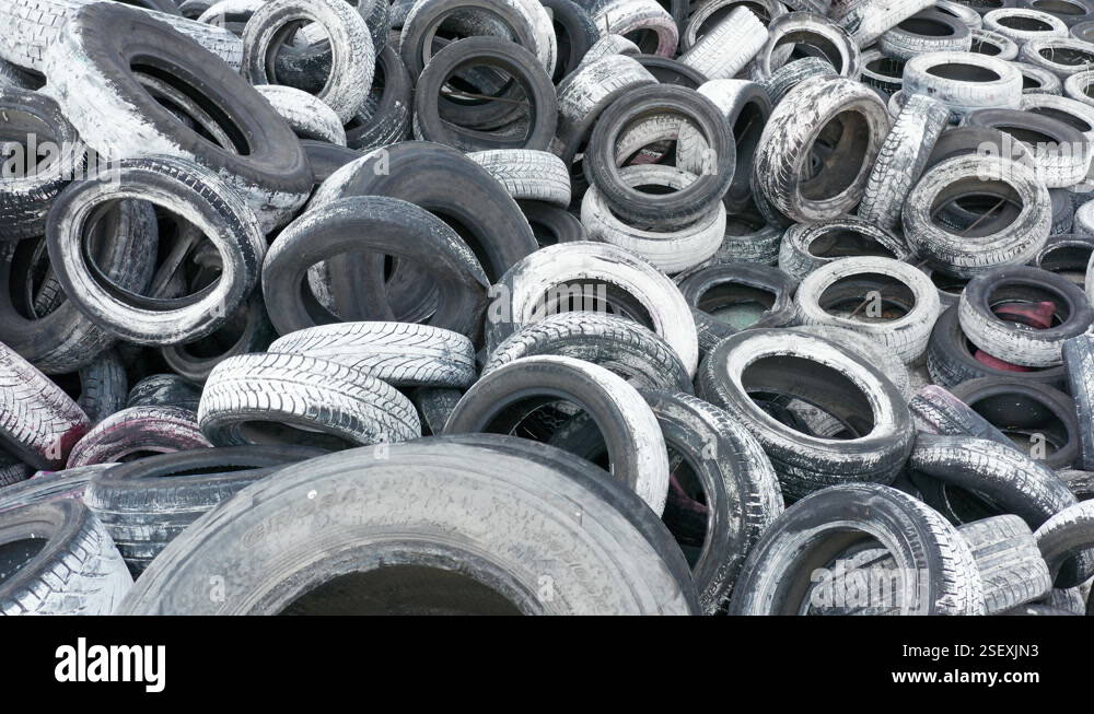 Pile of waste tires, dumped and ready for recycling. Heap of old scrap ...