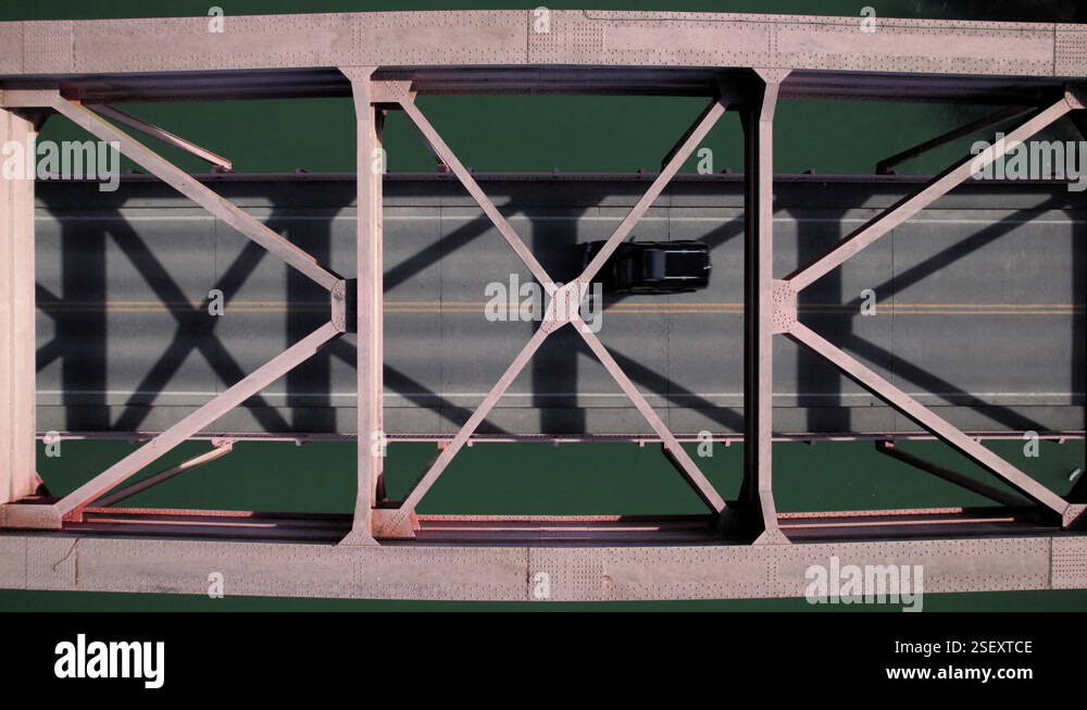 Looking Down Through Bridge Rafters at Black Car Crossing Bridge Over ...