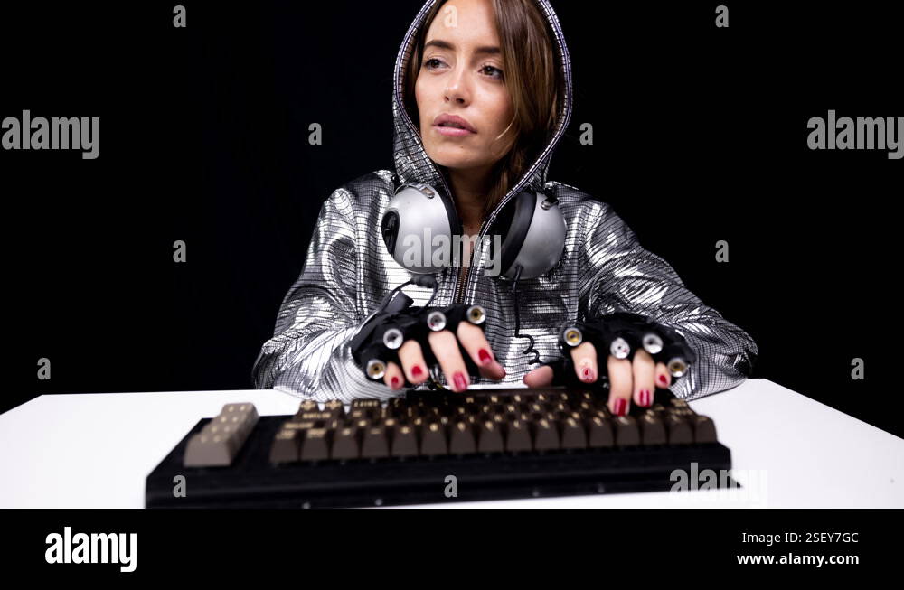Woman with silver hoodie typing on keyboard Stock Video Footage - Alamy
