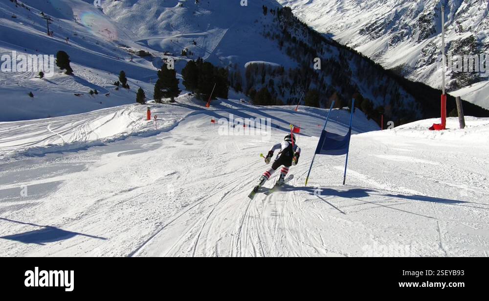 Young ski racer showing a downhill ski race start on a steep race ...