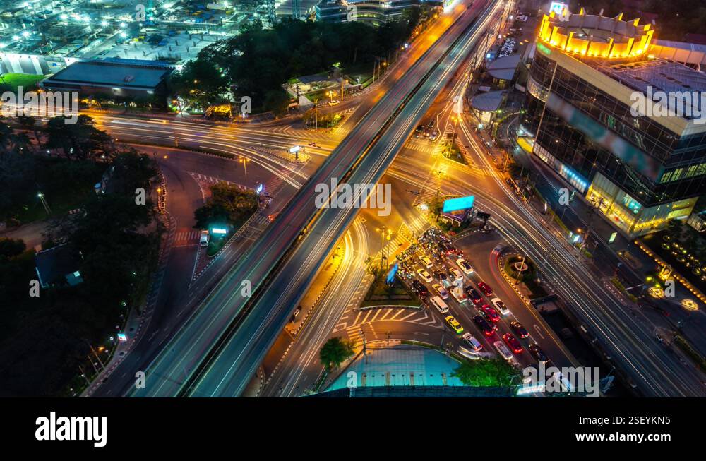 Time lapse of busy highway road junction in metropolis city center at ...
