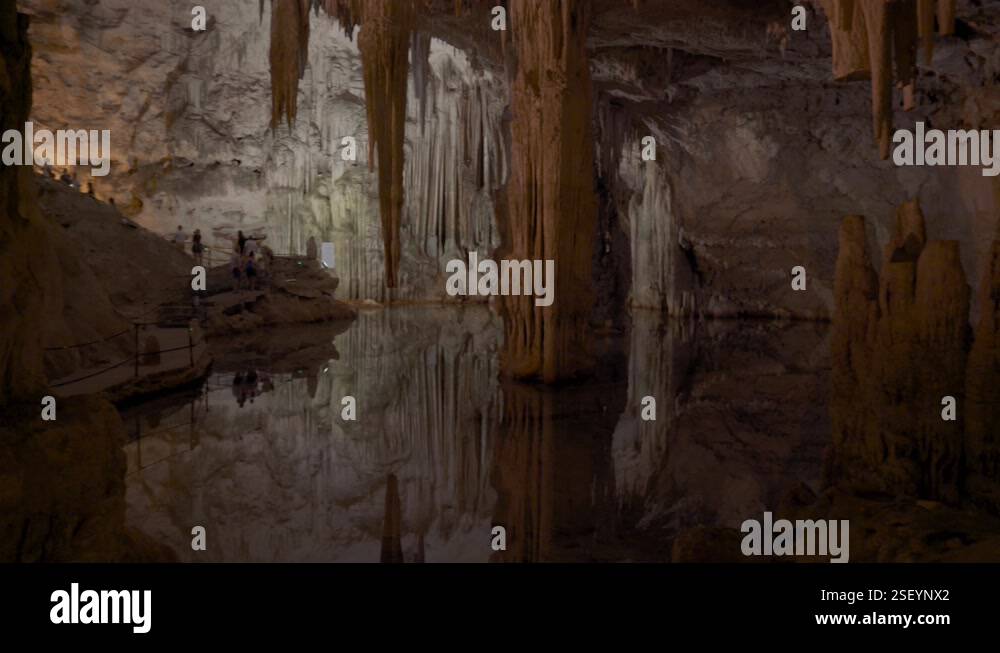 Water reflection at impressive limestone Neptune Cave with stalagmites ...