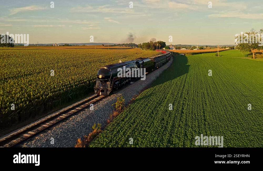 An Aerial View of a Steam Engine Puffing Smoke and Steam with Passenger ...