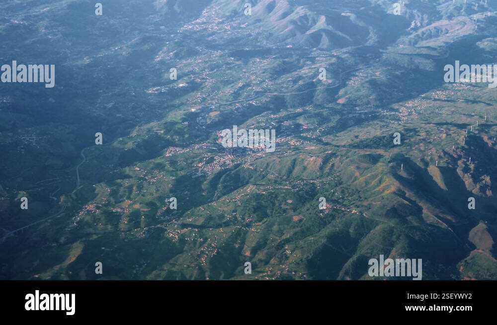 Travel flying above mountain range, looking to the right of the frame ...