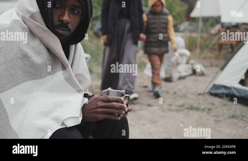 Homeless Black Man Drinking Hot Tea at Refugee Camp Stock Video Footage ...