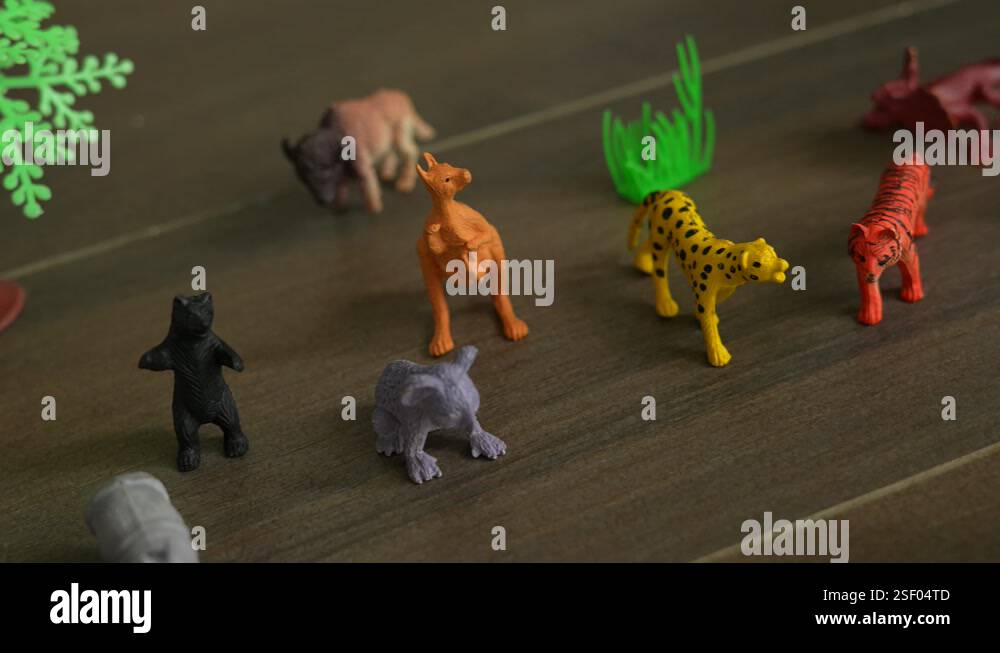 collection of plastic jungle animal toys for kids on the floor with ...