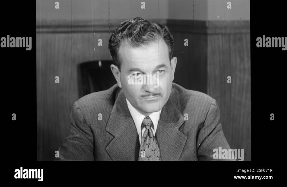 1950s: Man seated at table in restaurant talks. Man seated across the ...