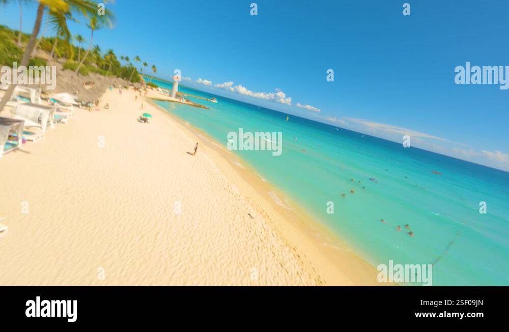 FPV drone shot around palm trees and over the Playa Dominicus beach, in ...