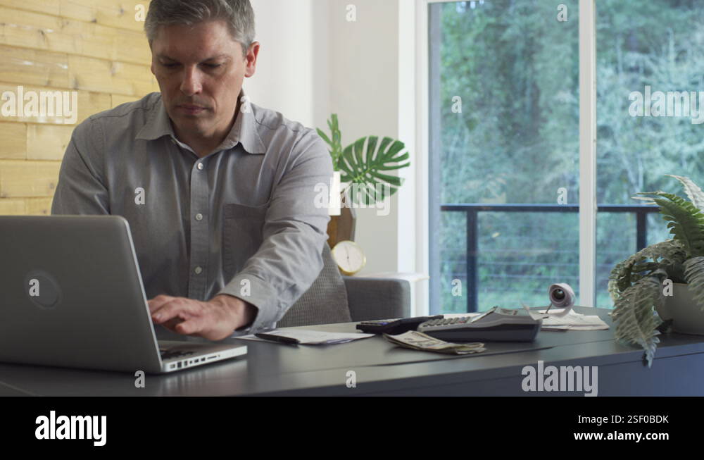 Man working on income tax return at home Stock Video Footage - Alamy