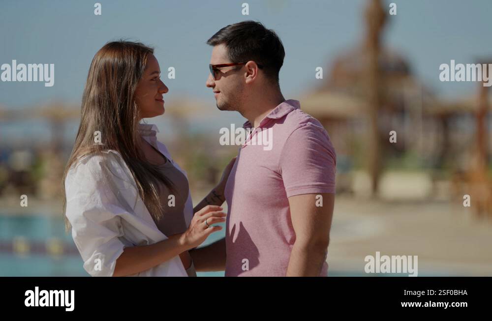 two lovers are kissing in hotel territory with pool in summer, love and ...