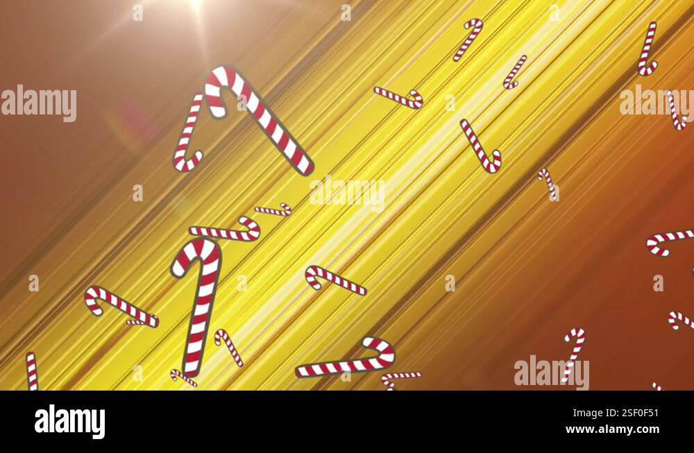 Multiple candy cane icons falling against spot of light and trails ...