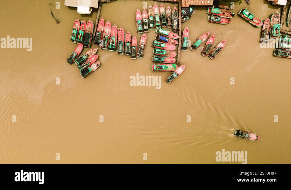 Southeast Asia's colorful trawler boats in port leaving their dock to ...