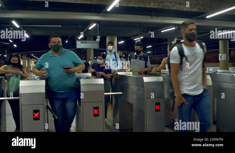Passengers swipe their fare cards at the turnstile to enter the metro ...