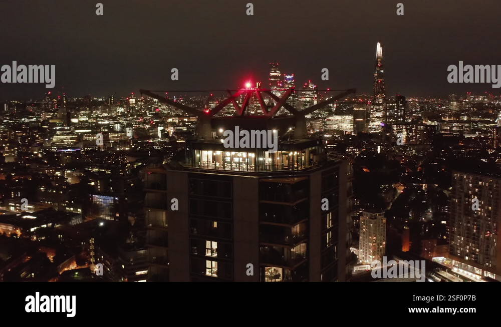 Fly around roof lookout terrace at tall apartment building. Night scene ...