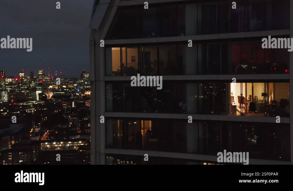 Descending shot along wall on modern high rise residential building ...