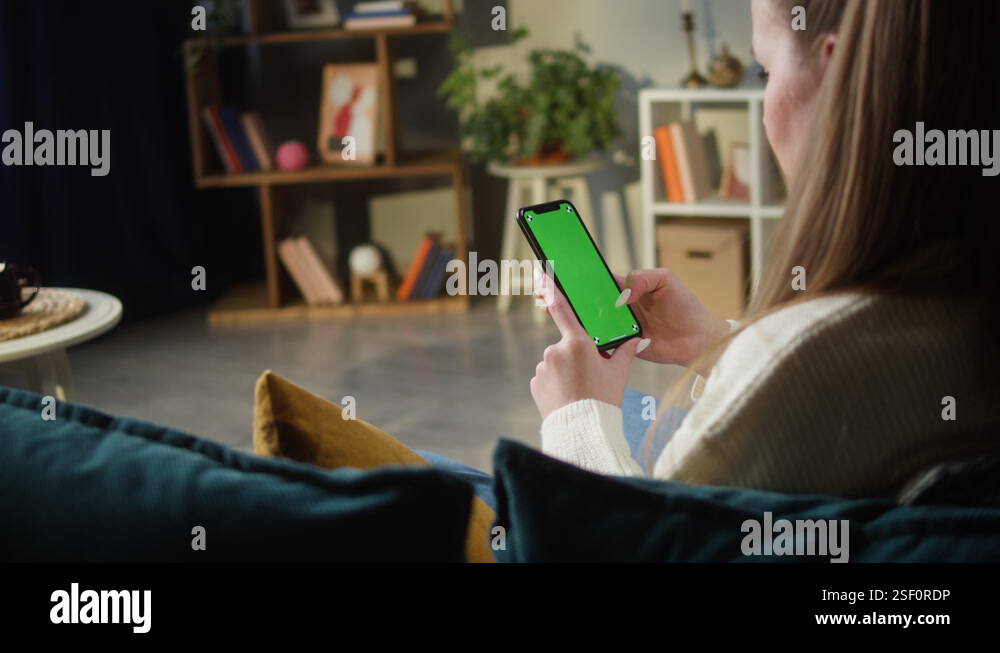 Woman using smartphone with green screen. Unrecognizable female person ...