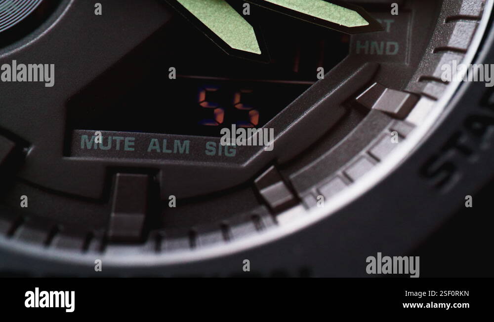 The minute hand moves on the black watch and the numbers on the dial ...