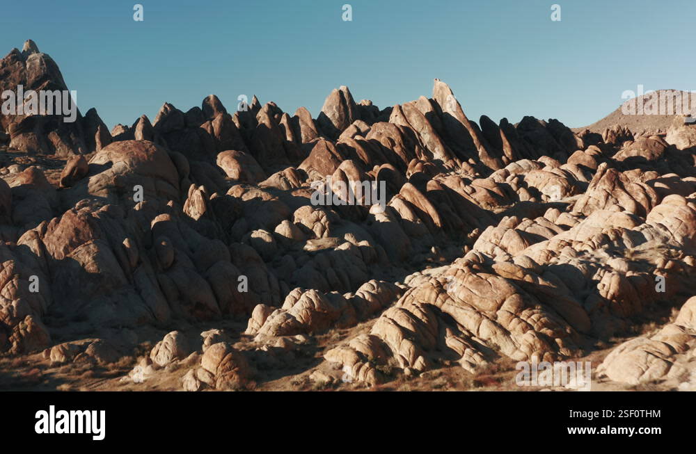 Drone flight above cinematic red stone peaks with weird rounded shape ...