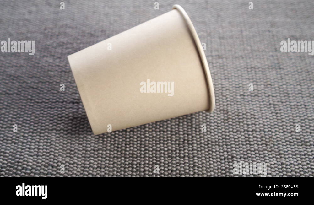 Throwing a recycled disposable paper cup on a rough texture Stock Video ...