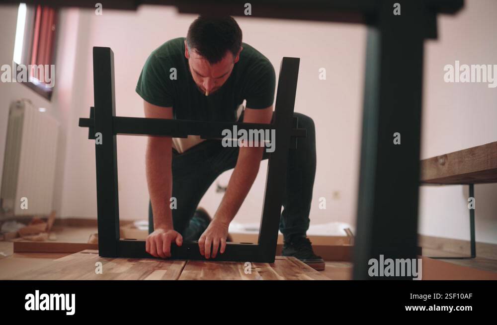 Assembling DIY Table. Man Installing Modern Metal Table Leg To Wooden ...