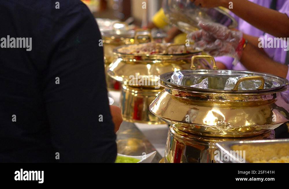 Slow motion video of people grab some food on their own plate in Indian ...