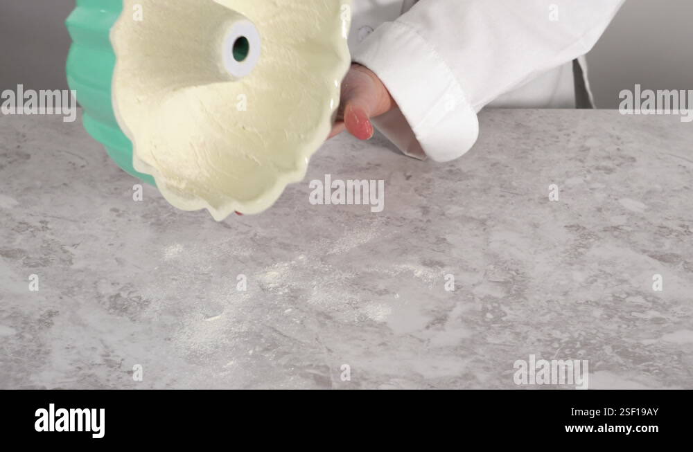 Greasing bundt cake pan with vegetable shortening and flour to bake ...