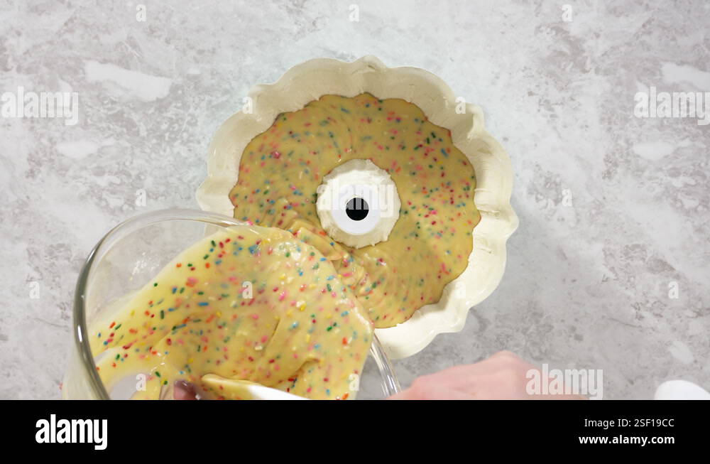 Pouring cake batter in a bundt cake pan to bake funfettti bundt cake ...
