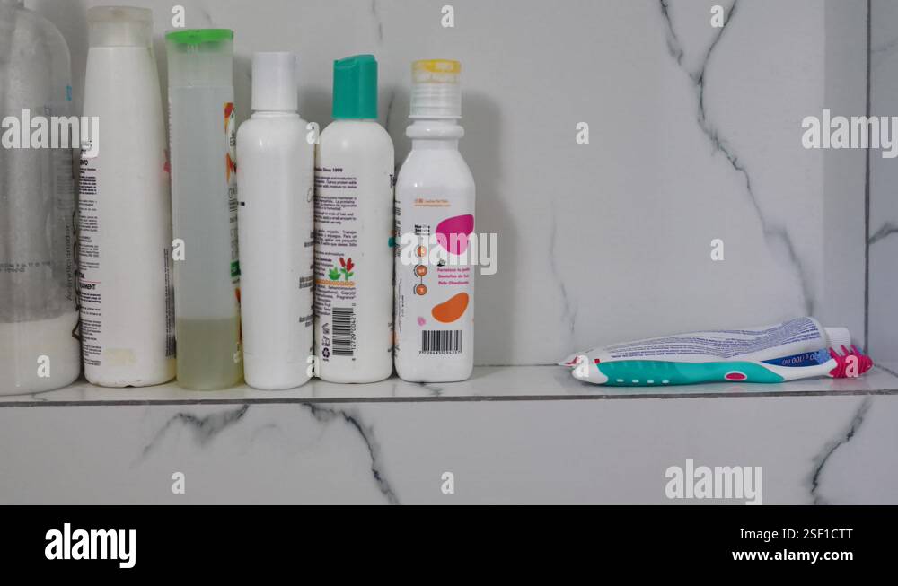 bottles of shampoo, toothpaste and toothbrush in the home bathroom ...