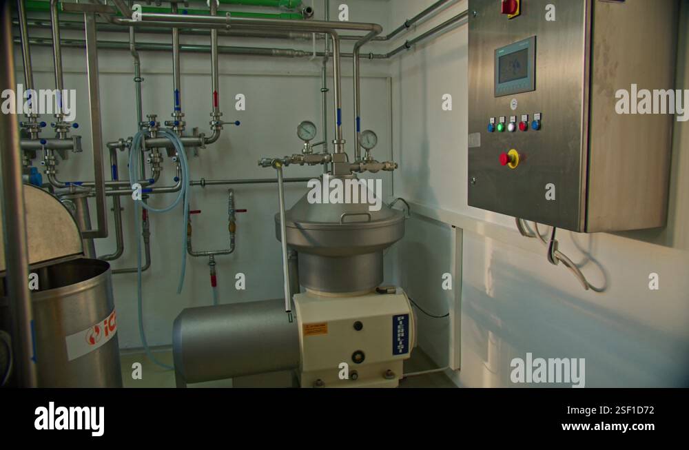 Small factory processing dairy products. Bio dairy farm. Foamy milk ...
