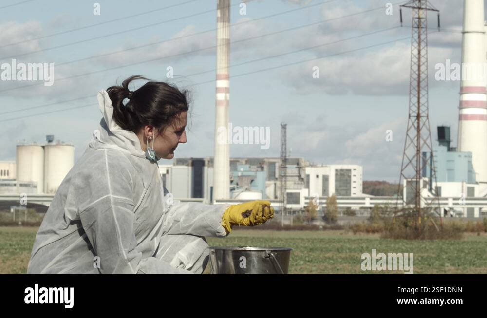 Laboratory worker is soil sampling field with power factory in ...
